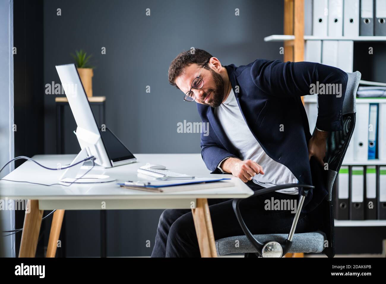 Young Man With Back Pain. Bad Office Posture Stock Photo - Alamy