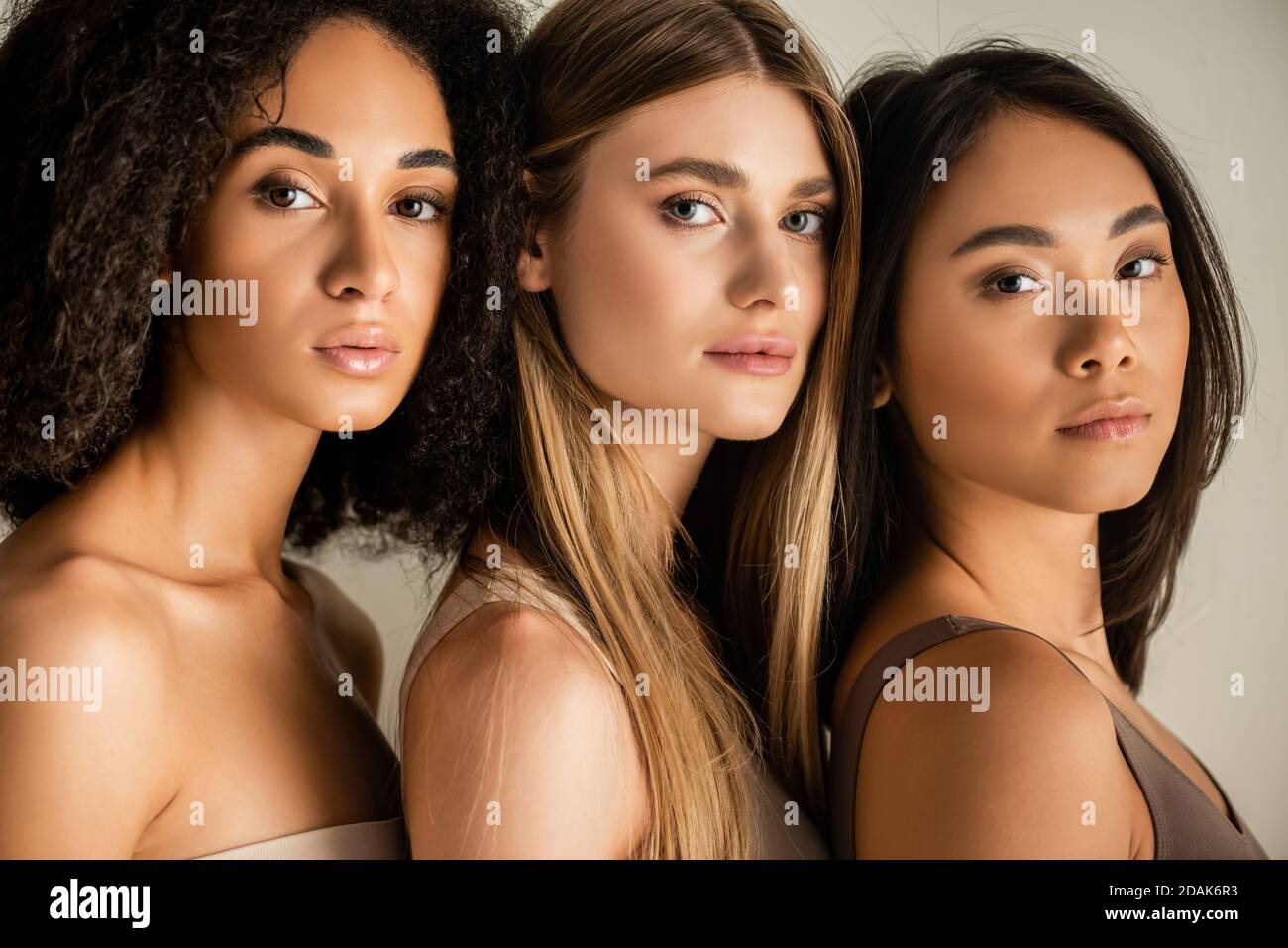 young multicultural models looking at camera isolated on white Stock ...