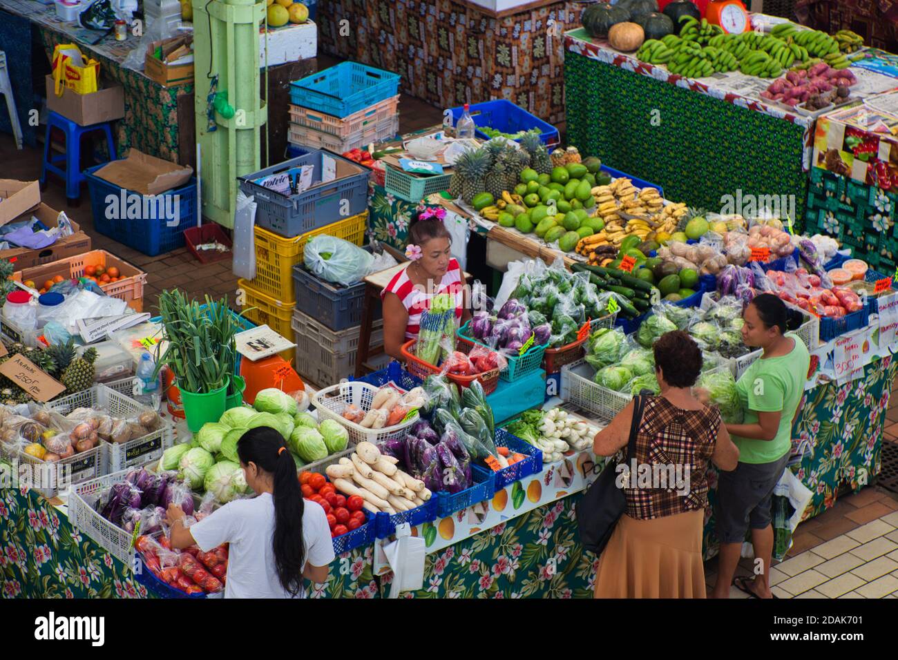 A Tahitian lady serves people from her stall of local and tropical ...