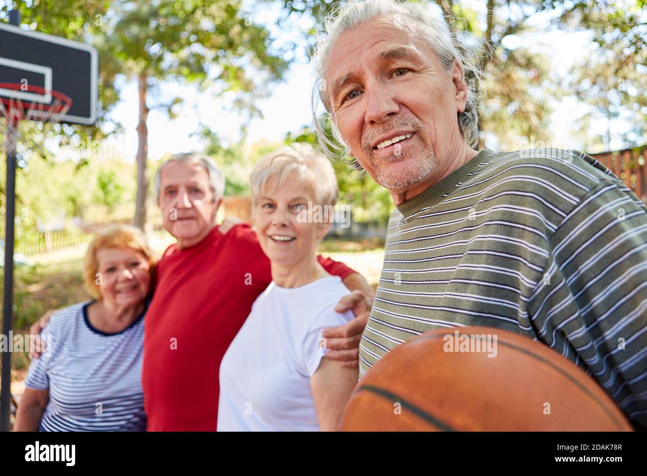Vital senior group as a sporty pensioner team during basketball ...