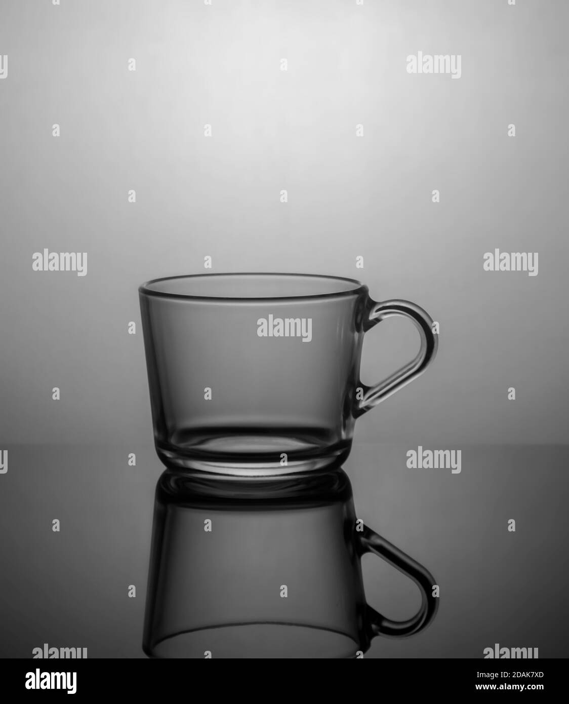 Empty tea cup on dark background with back light Stock Photo - Alamy
