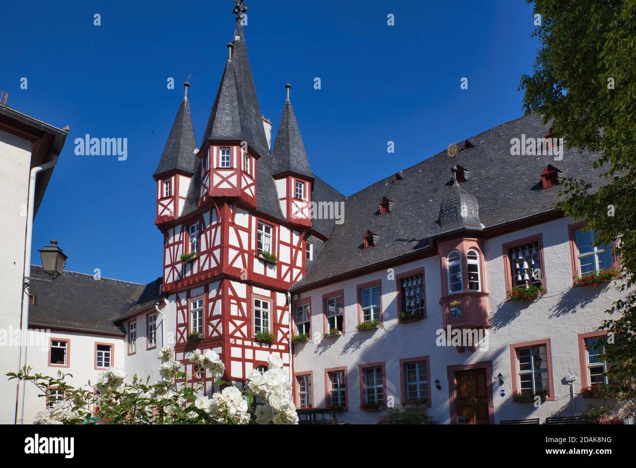 Very ornate decorated tower with pointed turrets on top on a large ...