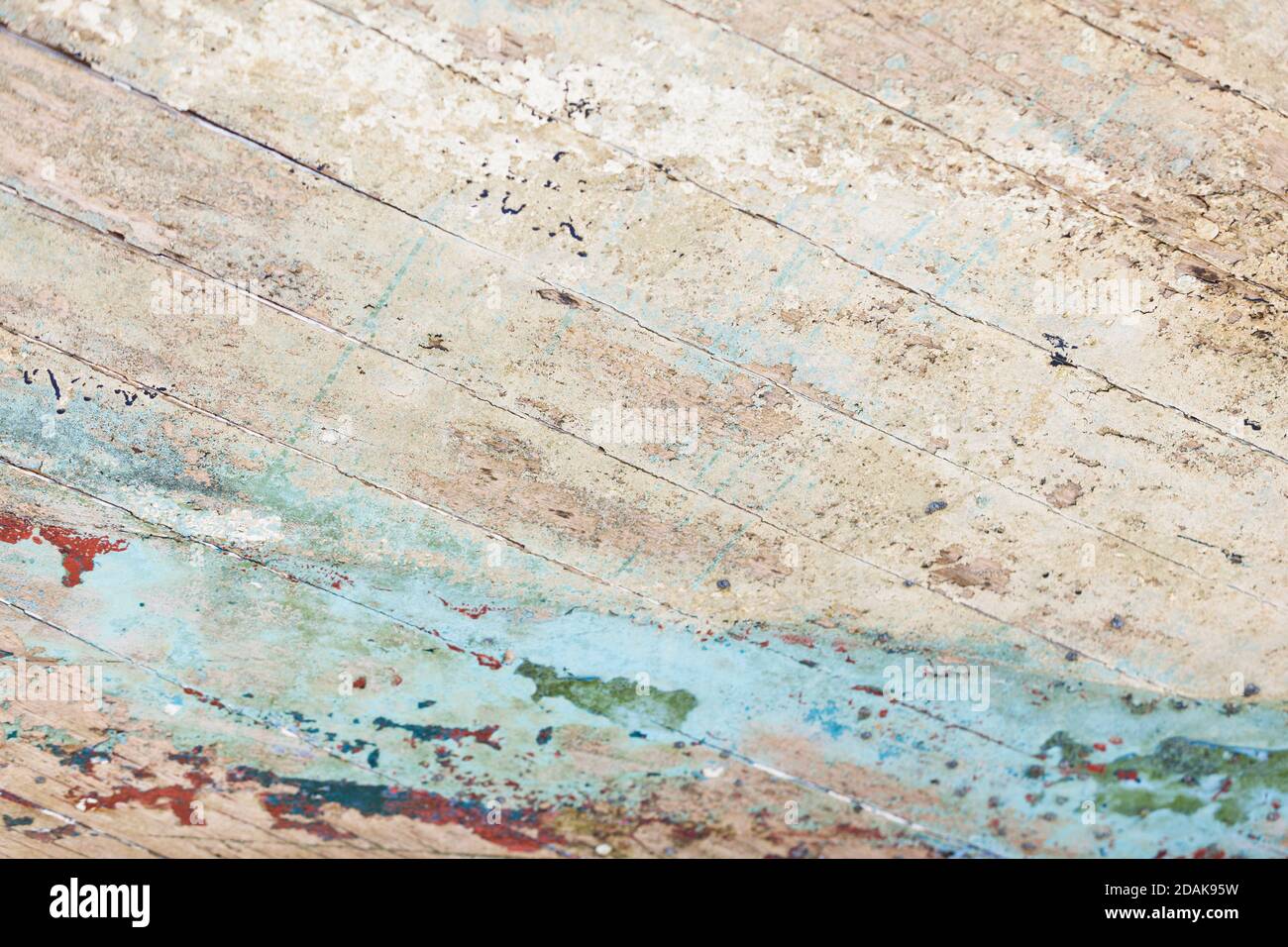 Detail of an old wooden ship hull with paint residue and rust. Portbail ...