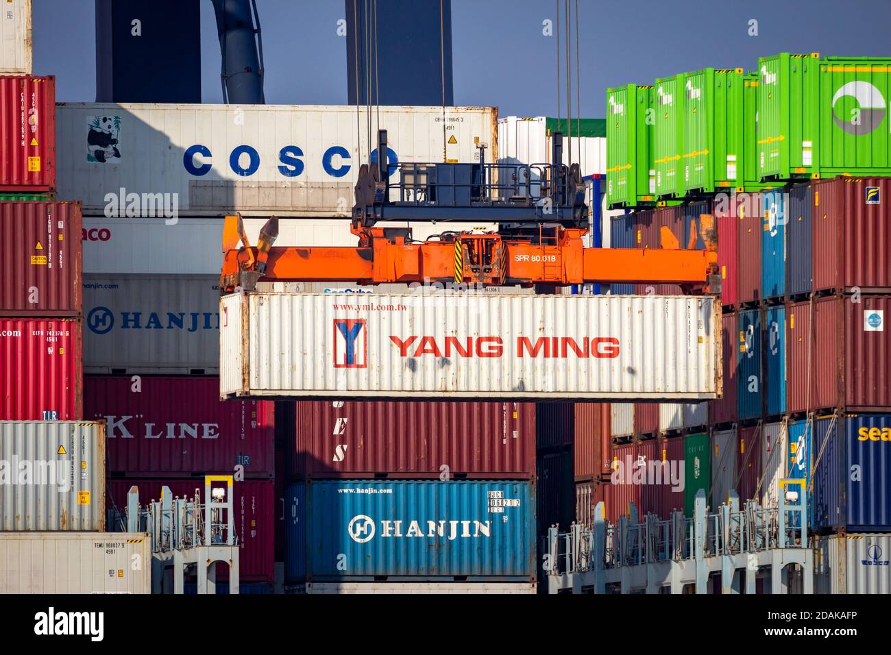 Crane operator unloading a sea container from a cargo ship the Port of ...