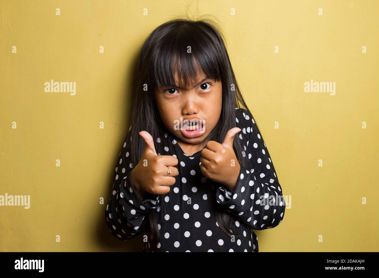asian little girl showing a OK hand sign Stock Photo - Alamy