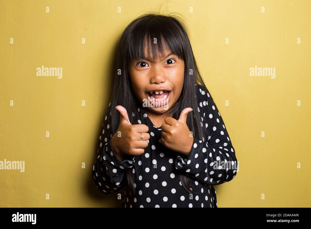 asian little girl showing a OK hand sign Stock Photo - Alamy