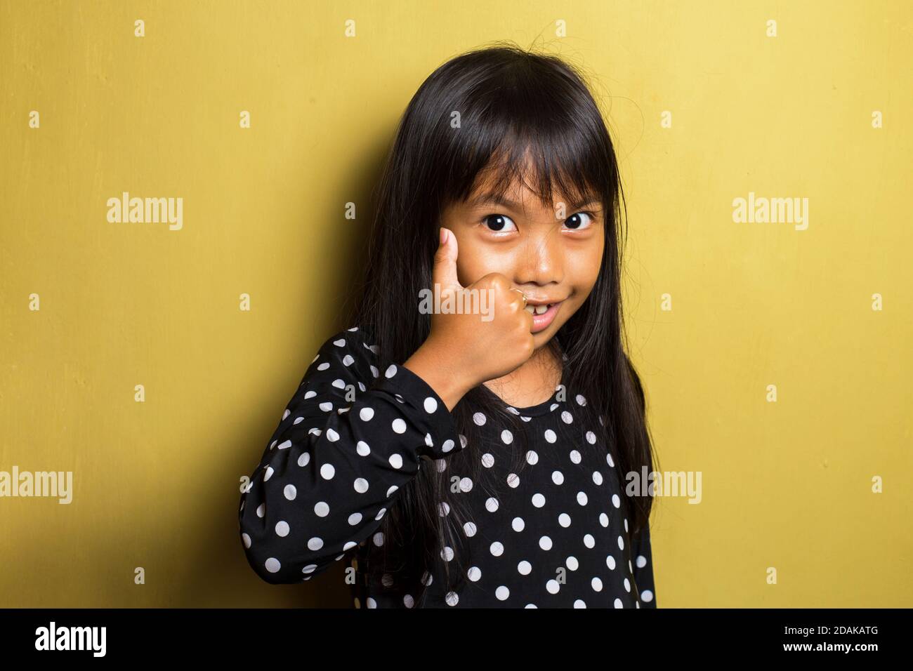asian little girl showing a OK hand sign Stock Photo - Alamy
