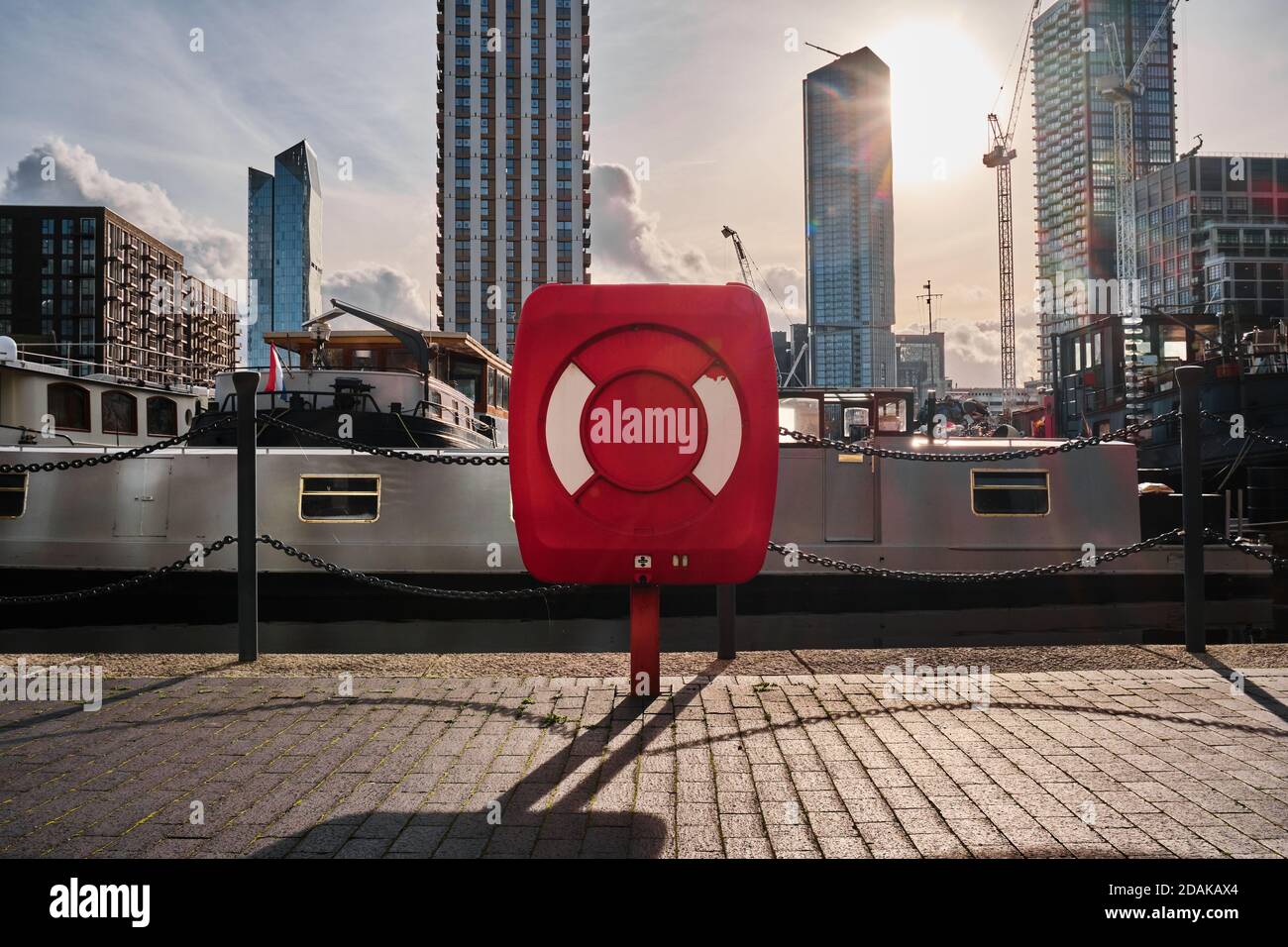 Red Life buoy and narrowboat in sunlight, Blackwall Basin, London Stock ...
