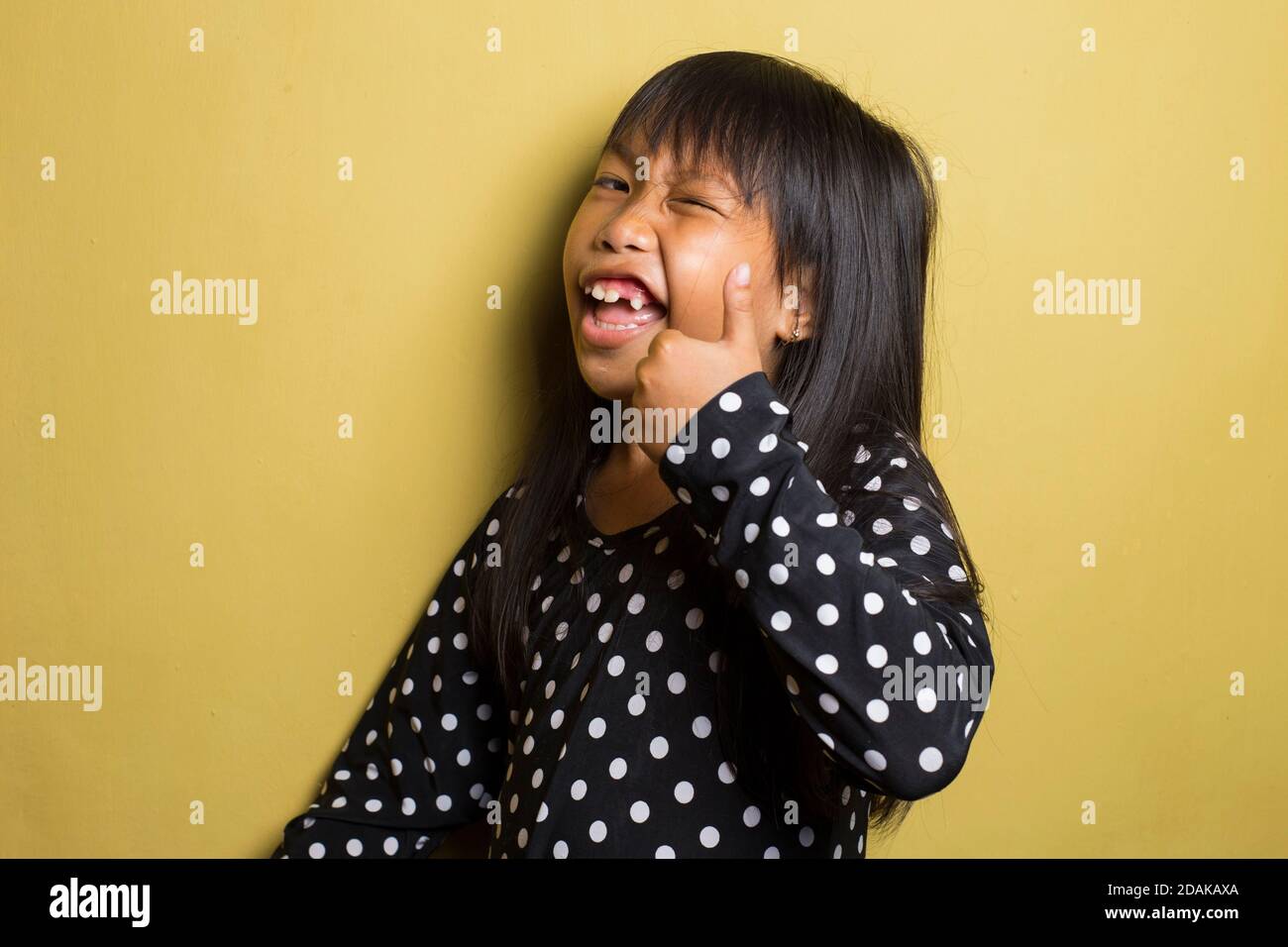 asian little girl showing a OK hand sign Stock Photo - Alamy