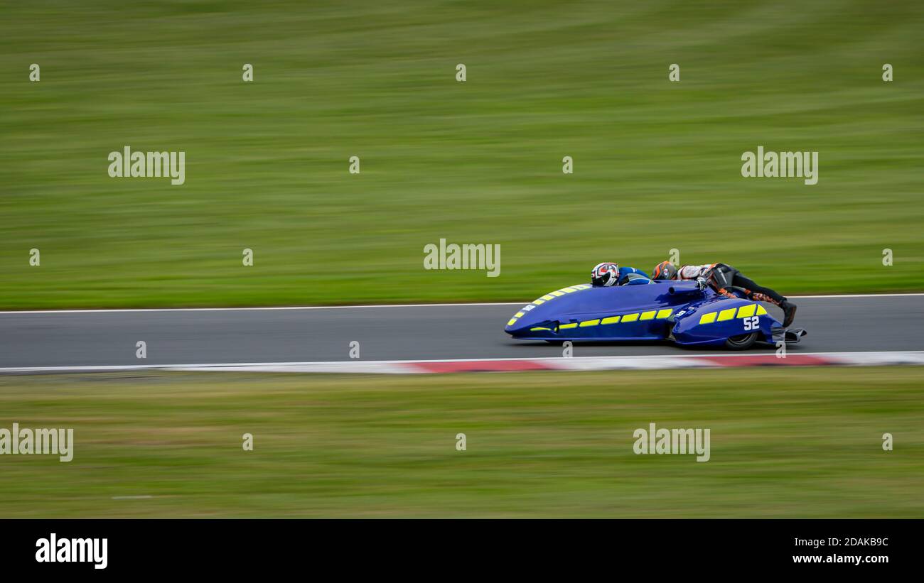 A panning shot of a racing sidecar as it corners on a track Stock Photo ...