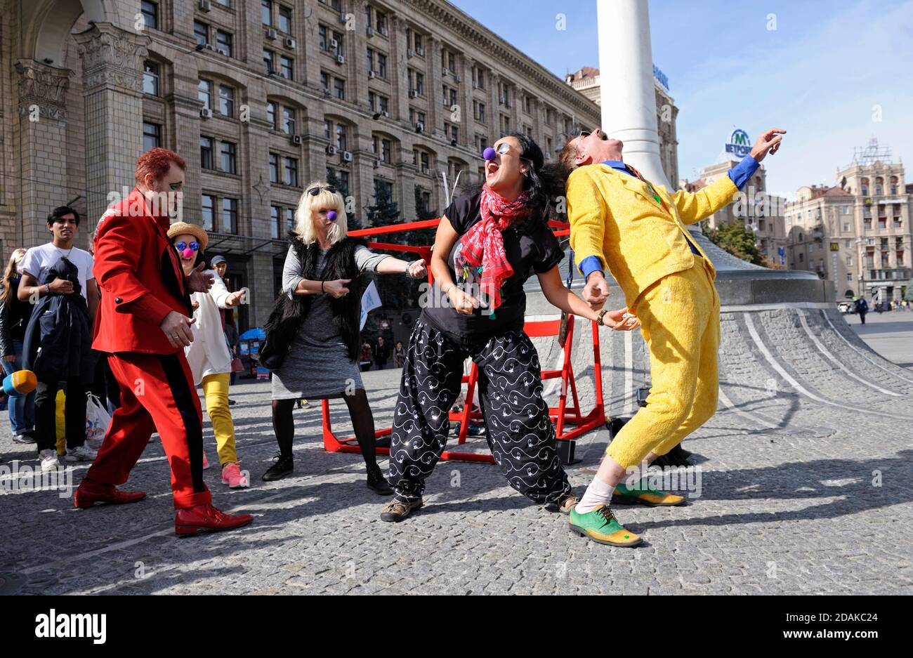 Street clowns performing an interactive show on square of city Stock ...