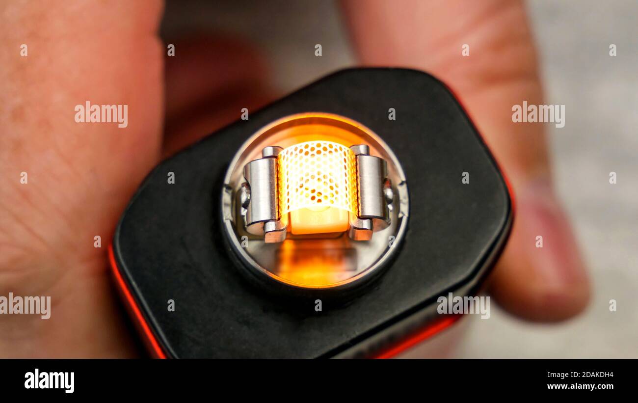 Preparation of mesh coil in the atomizer for vaping - Brightly glowing ...