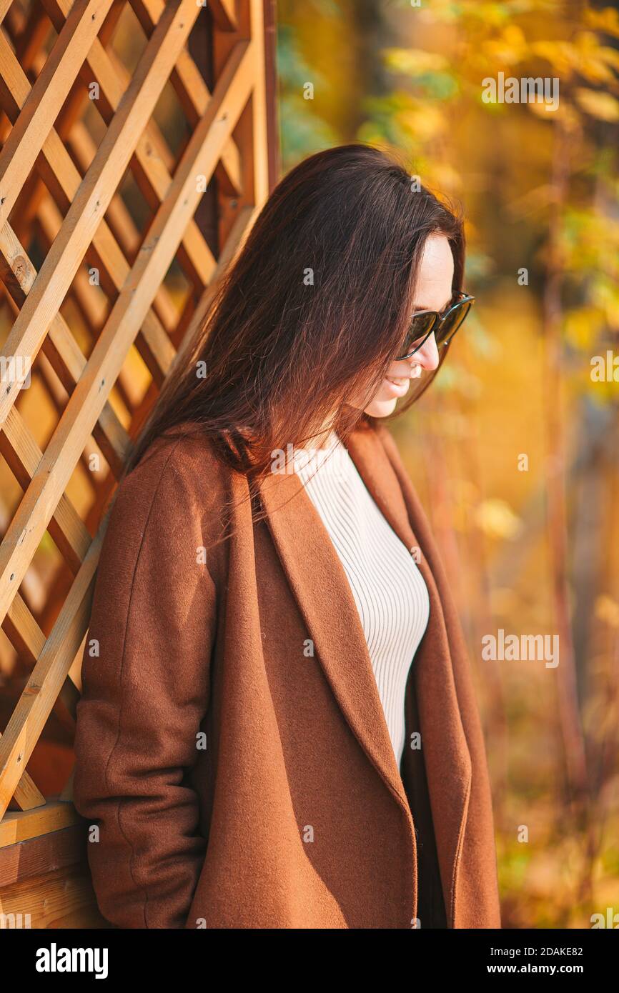 Beautiful woman in autumn park under fall foliage Stock Photo - Alamy