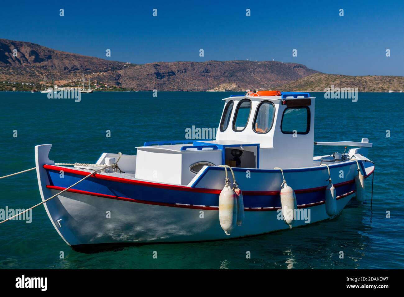 Colorful traditional Greek fishing boat moored at a small harbour in ...