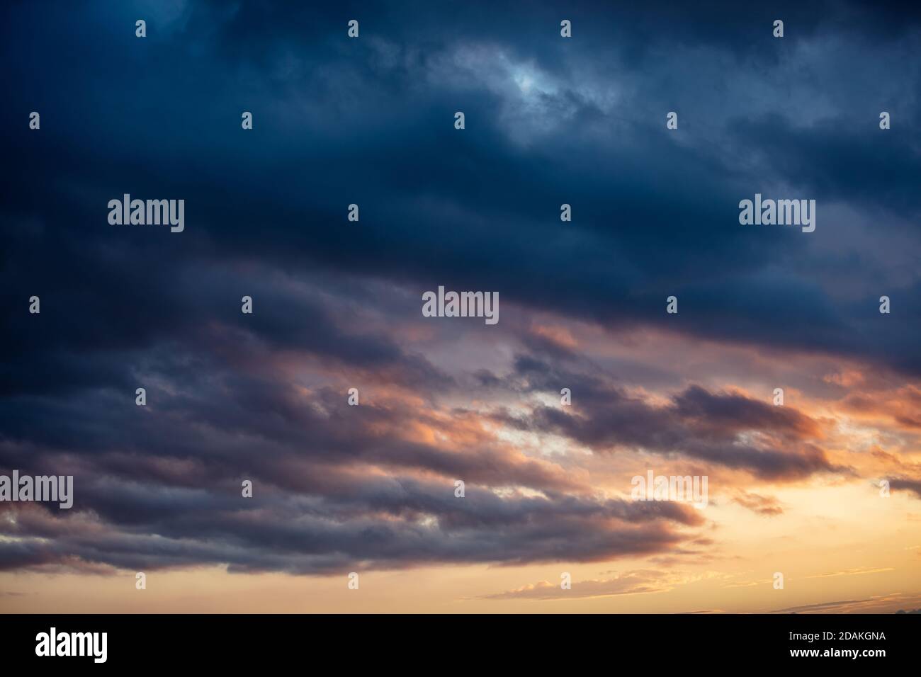 Sunset heavy dark clouds. Dramatic magical sunrise cloudscape over blue ...
