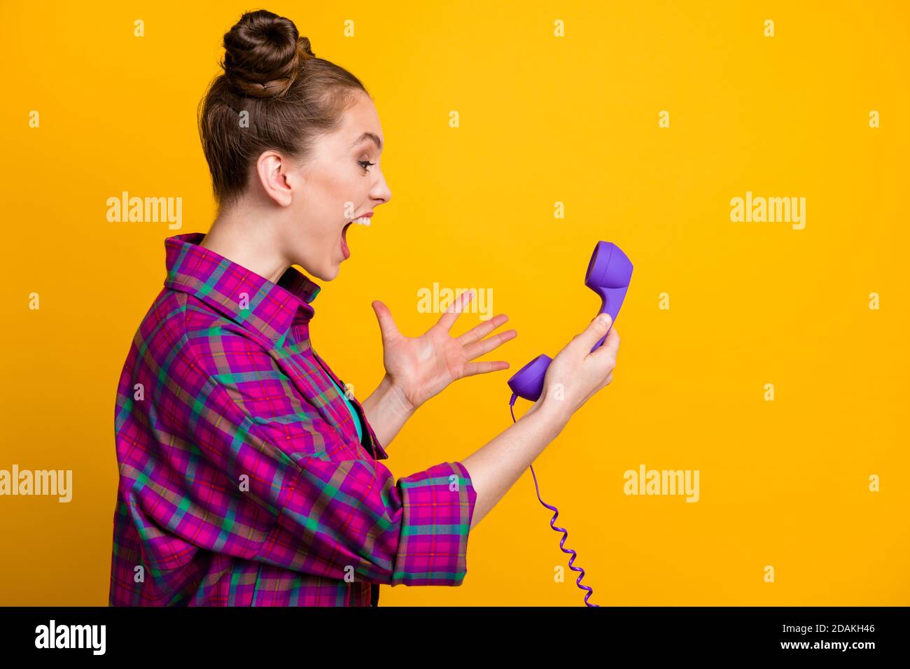 Profile photo of crazy angry furious lady two funny buns yell into ...