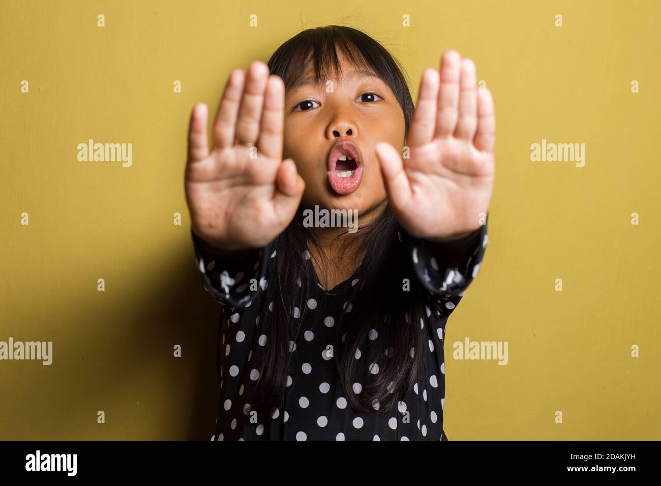 Asian little girl making stop gesture with her hand Stock Photo - Alamy