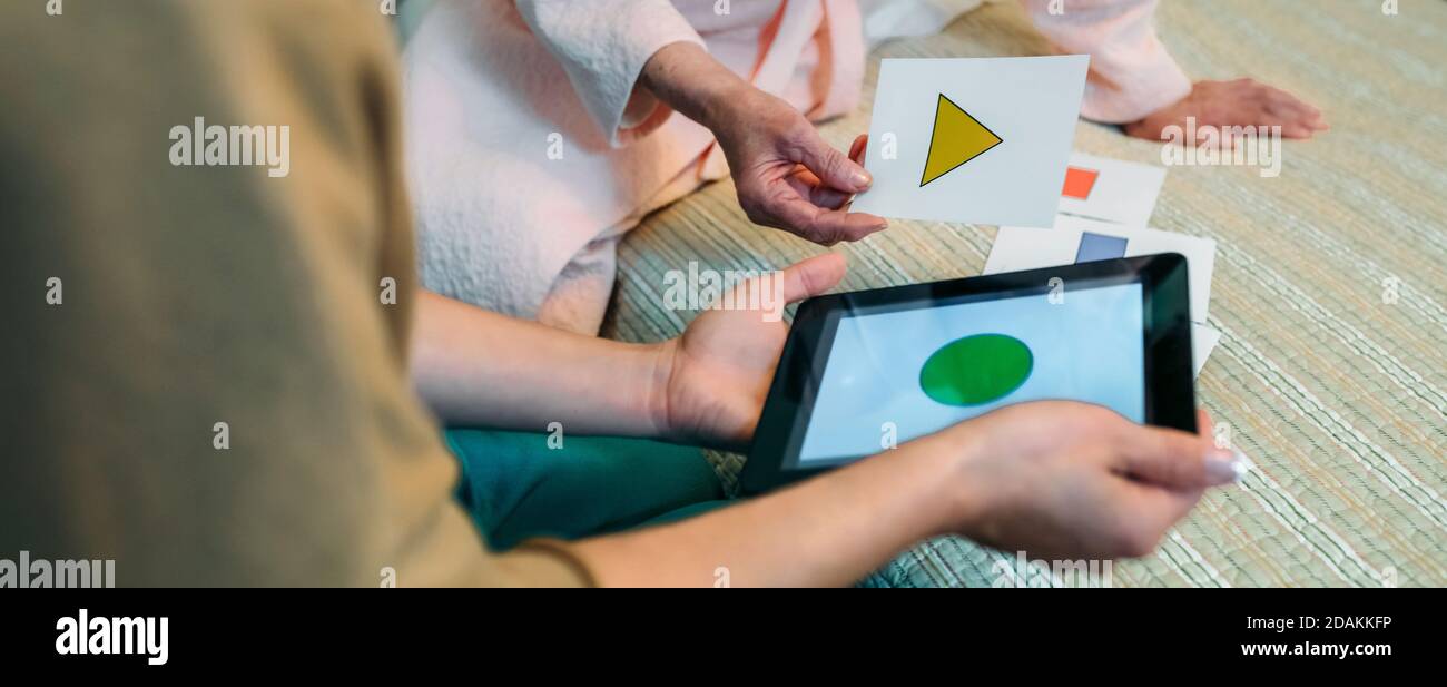 Female doctor showing geometric shapes to elderly patient Stock Photo ...