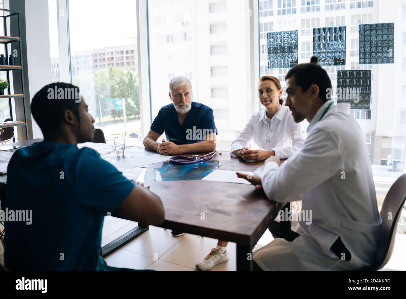 Medical team of doctors on meeting in medical office discussion about ...