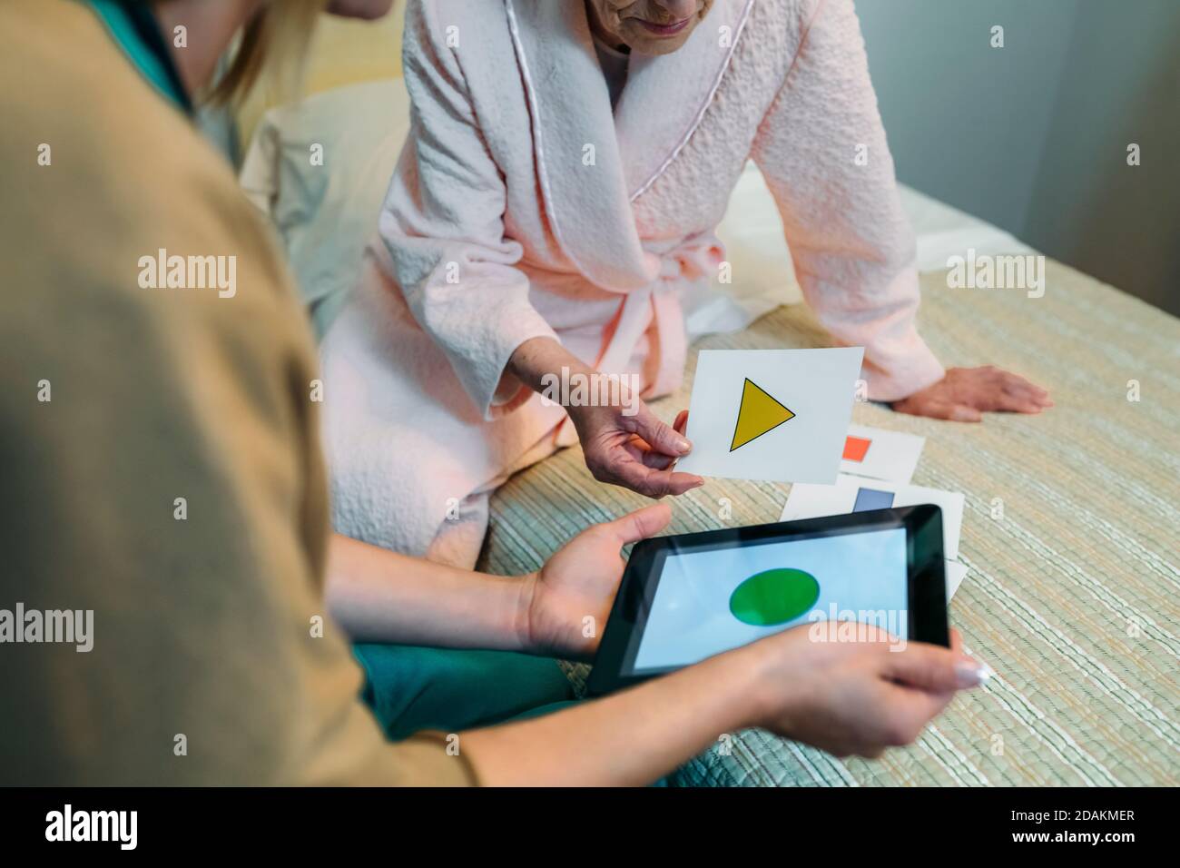 Female doctor showing geometric shapes to elderly patient Stock Photo ...