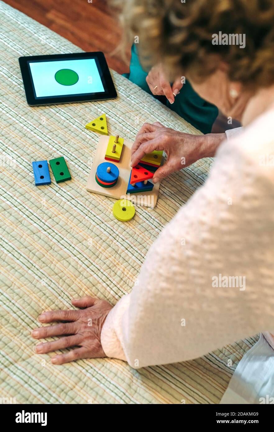 Female doctor showing geometric shapes to elderly patient Stock Photo ...