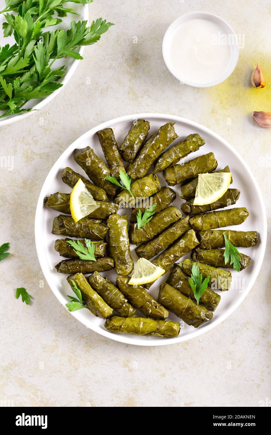Dolma, stuffed grape leaves with rice and meat on light stone ...