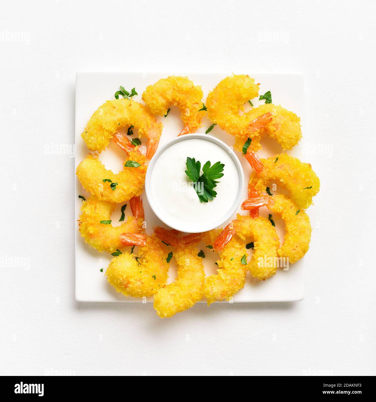 Deep fried breaded prawn on white plate over light stone background ...