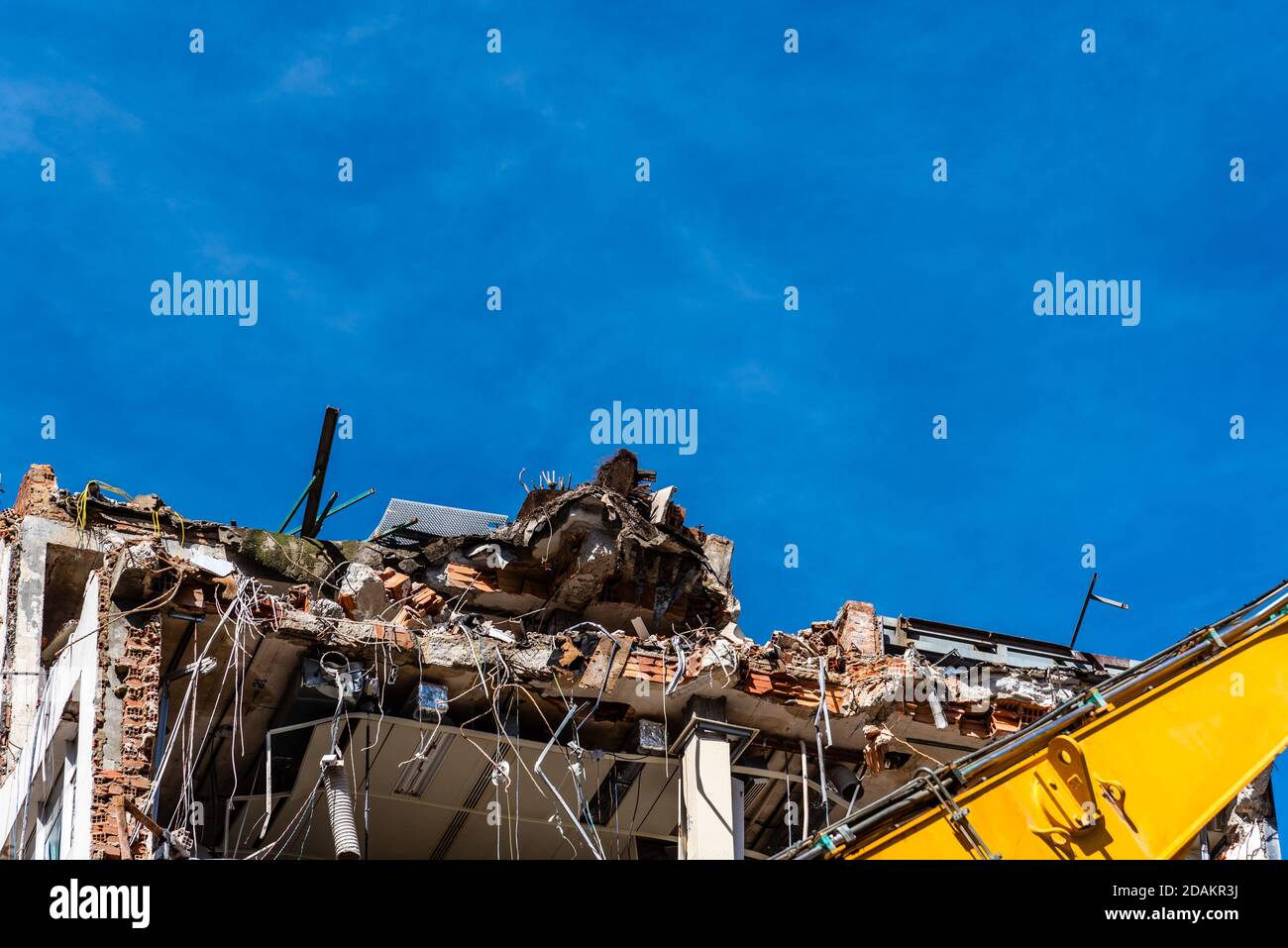 Giant semi demolished and broken building with open wires hanging from ...