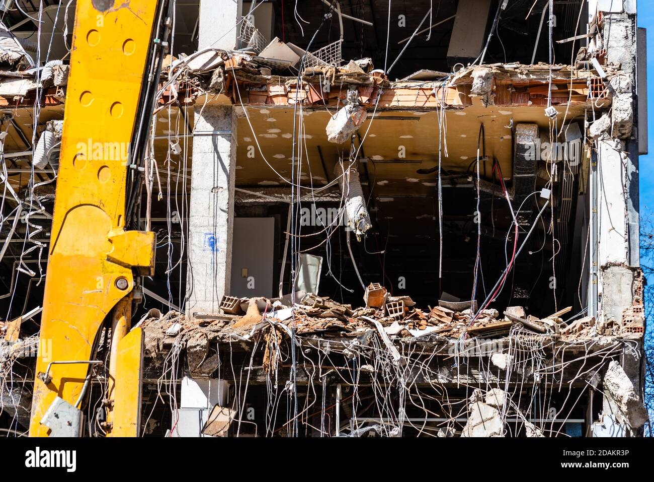 Giant semi demolished and broken building with open wires hanging from ...