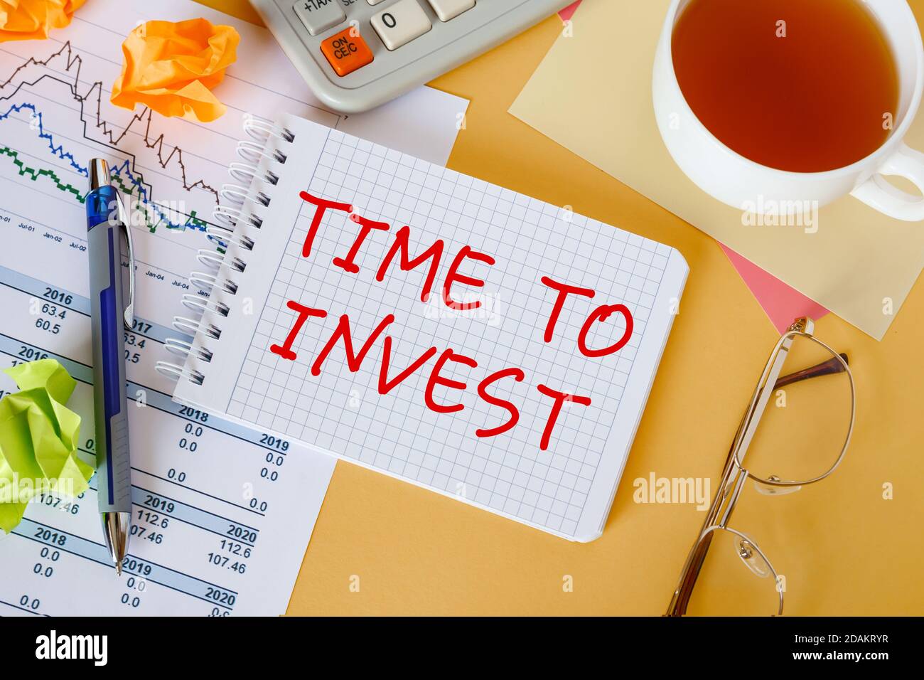 Desktop with documents, calculator and notepad. On the notebook is the ...