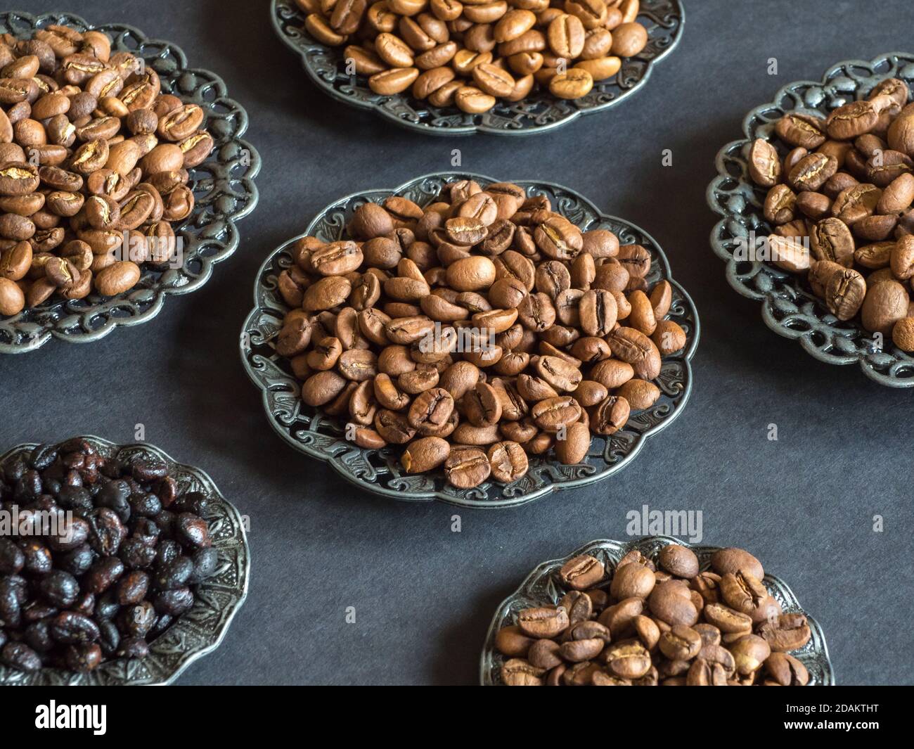 Different varieties of roasted coffee beans on a black background Stock ...