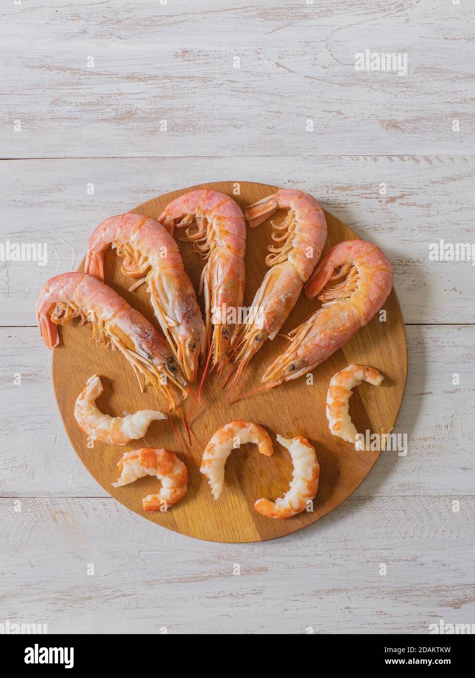 Cooked fresh giant prawns on a wooden chopping board. Top view Stock ...