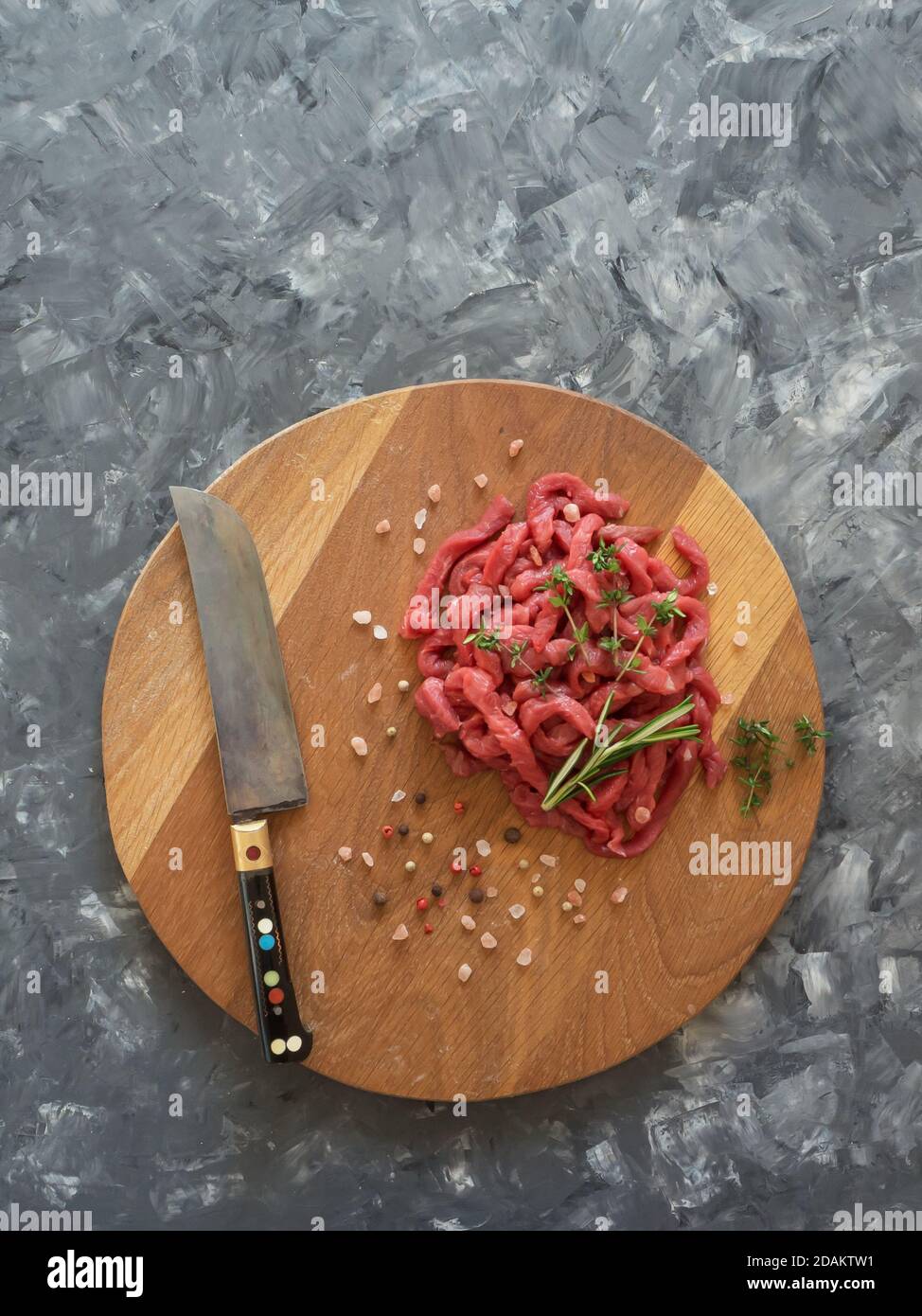 Sliced raw meat on a wooden board. Preparation of beef Stroganoff Stock ...