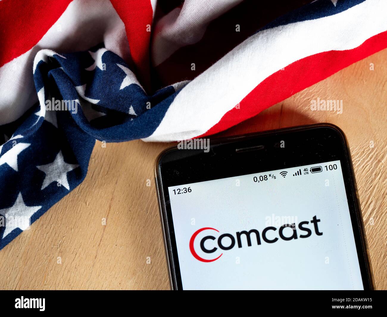In this photo illustration a Comcast logo is seen displayed on a ...