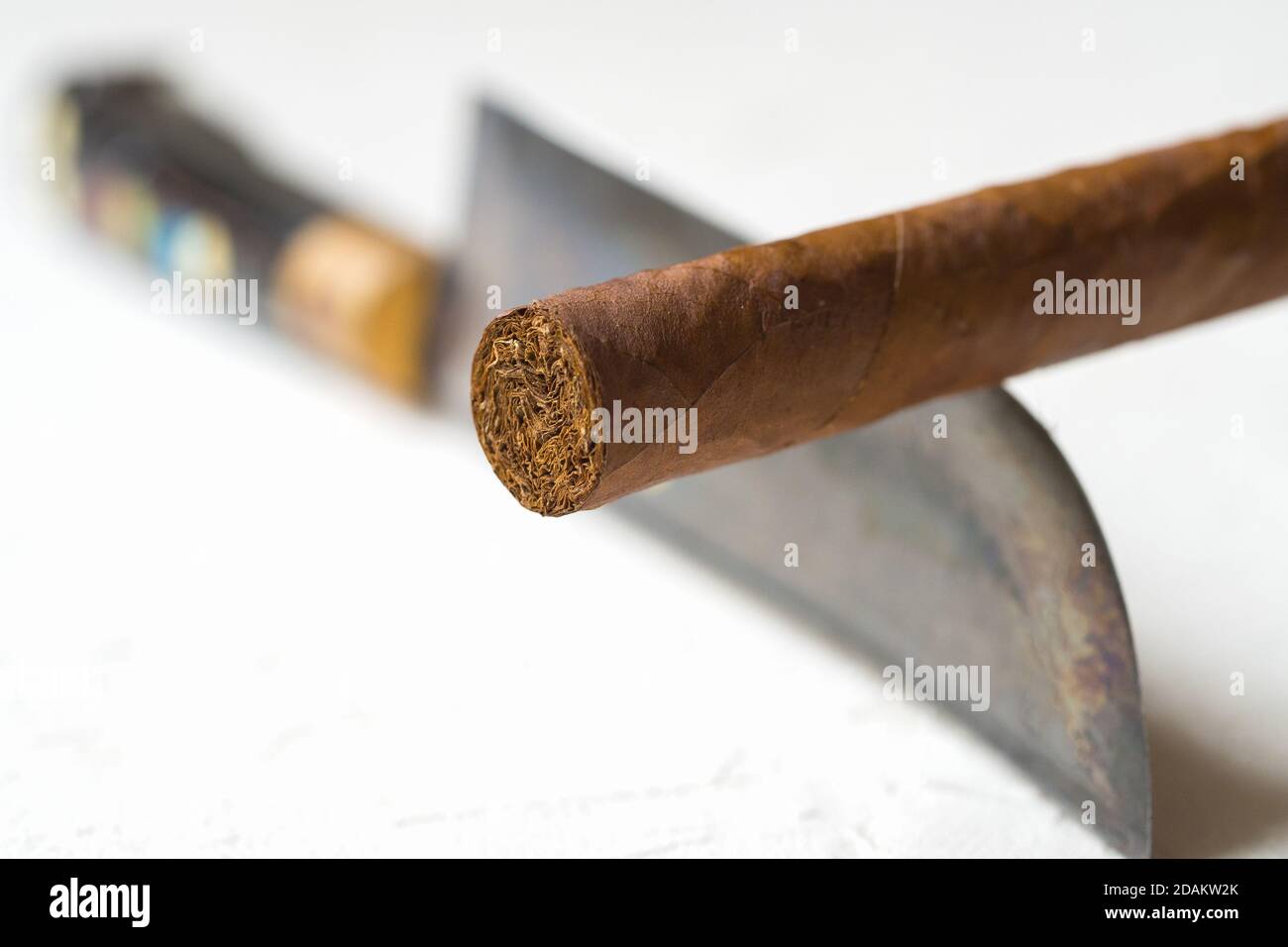 Cigar balancing on a knife edge. The concept of dangers of smoking ...