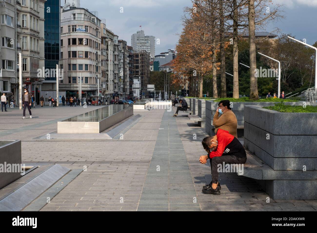 Men sit and rest on a bench in Taksim Square Stock Photo - Alamy