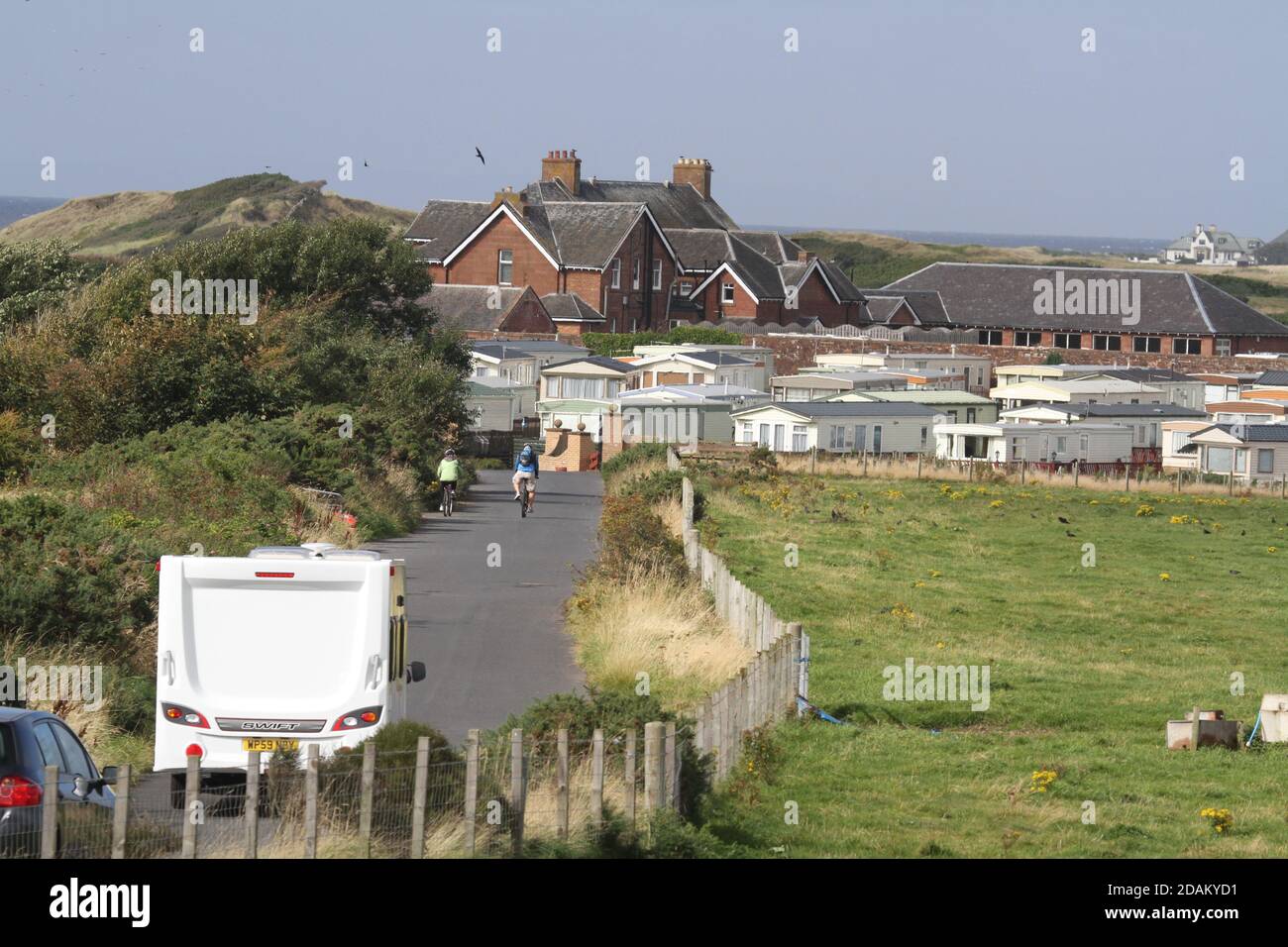 Prestwick, South Ayrshire, Scotland, UK. Cyclists heading down road ...