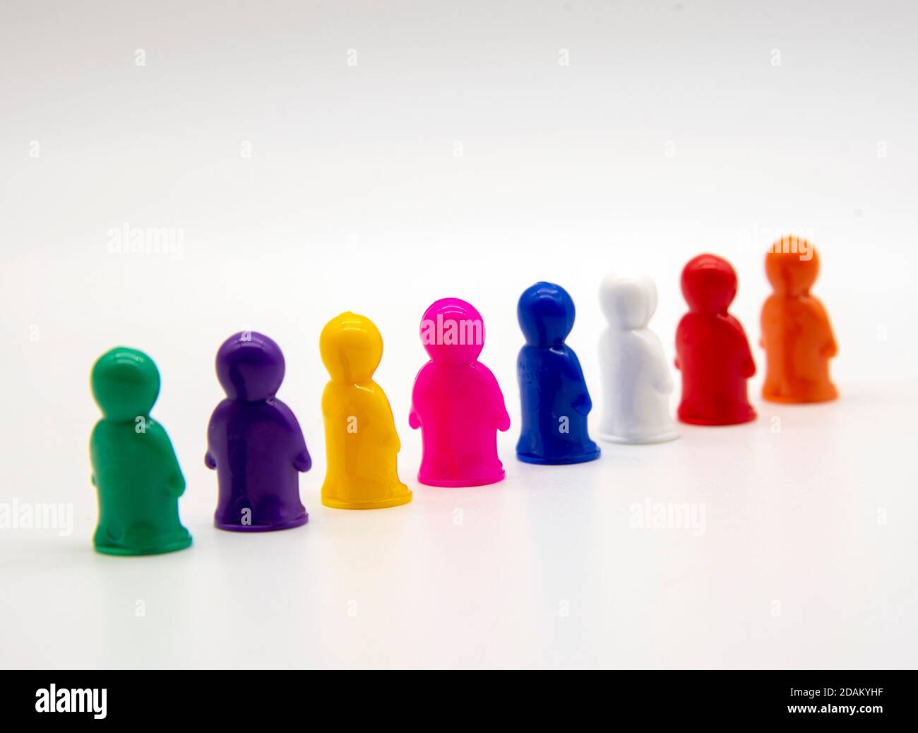Miniature toy figures stand in formation on a white background Stock ...