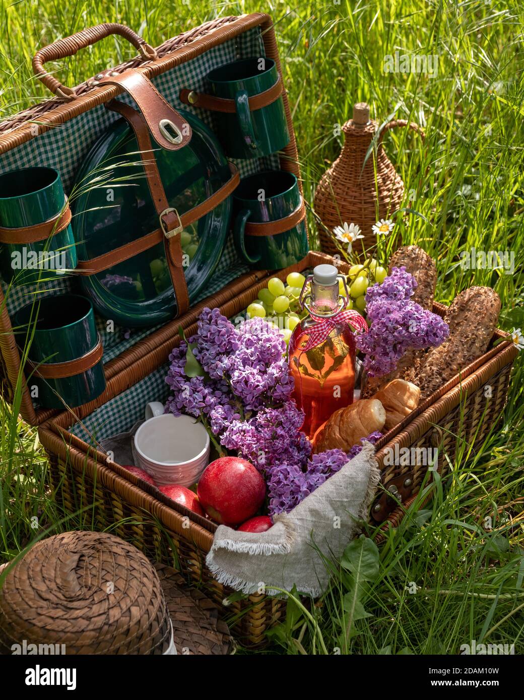 Pastry, bread, apples and other food in a picnic basket on grass Stock ...