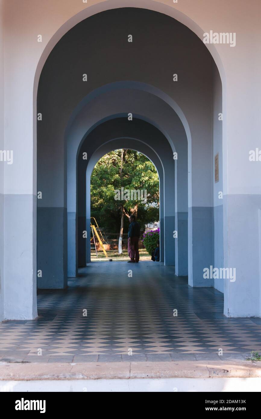 Aregua, Paraguay. 16th March, 2008. A man stands alone in arch corridor ...