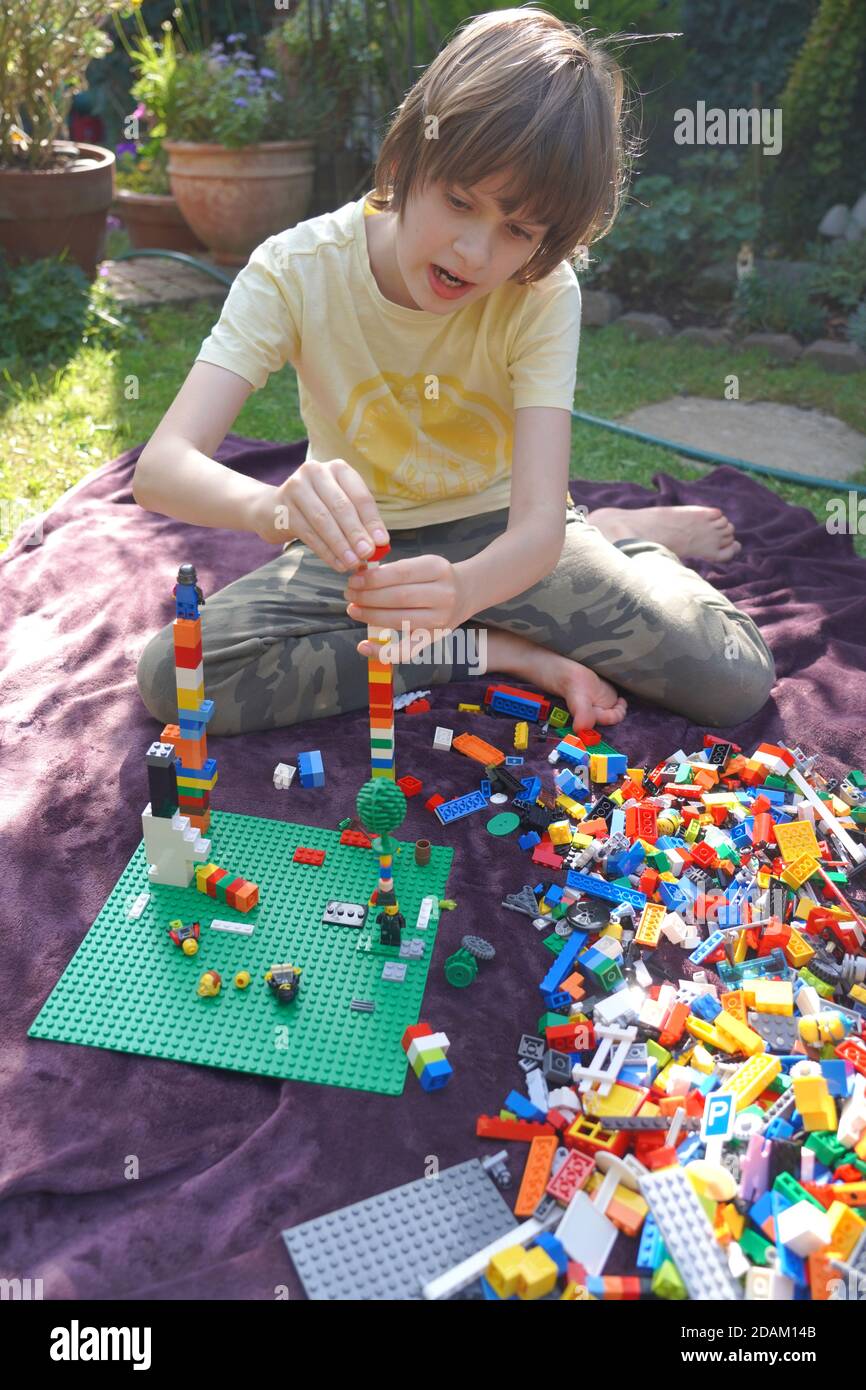 Child playing with lego outdoor Stock Photo - Alamy