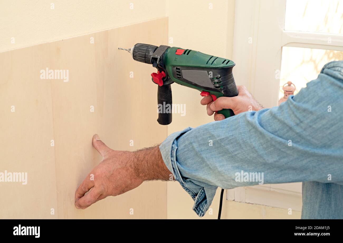 Human hand holding drill machine Stock Photo - Alamy