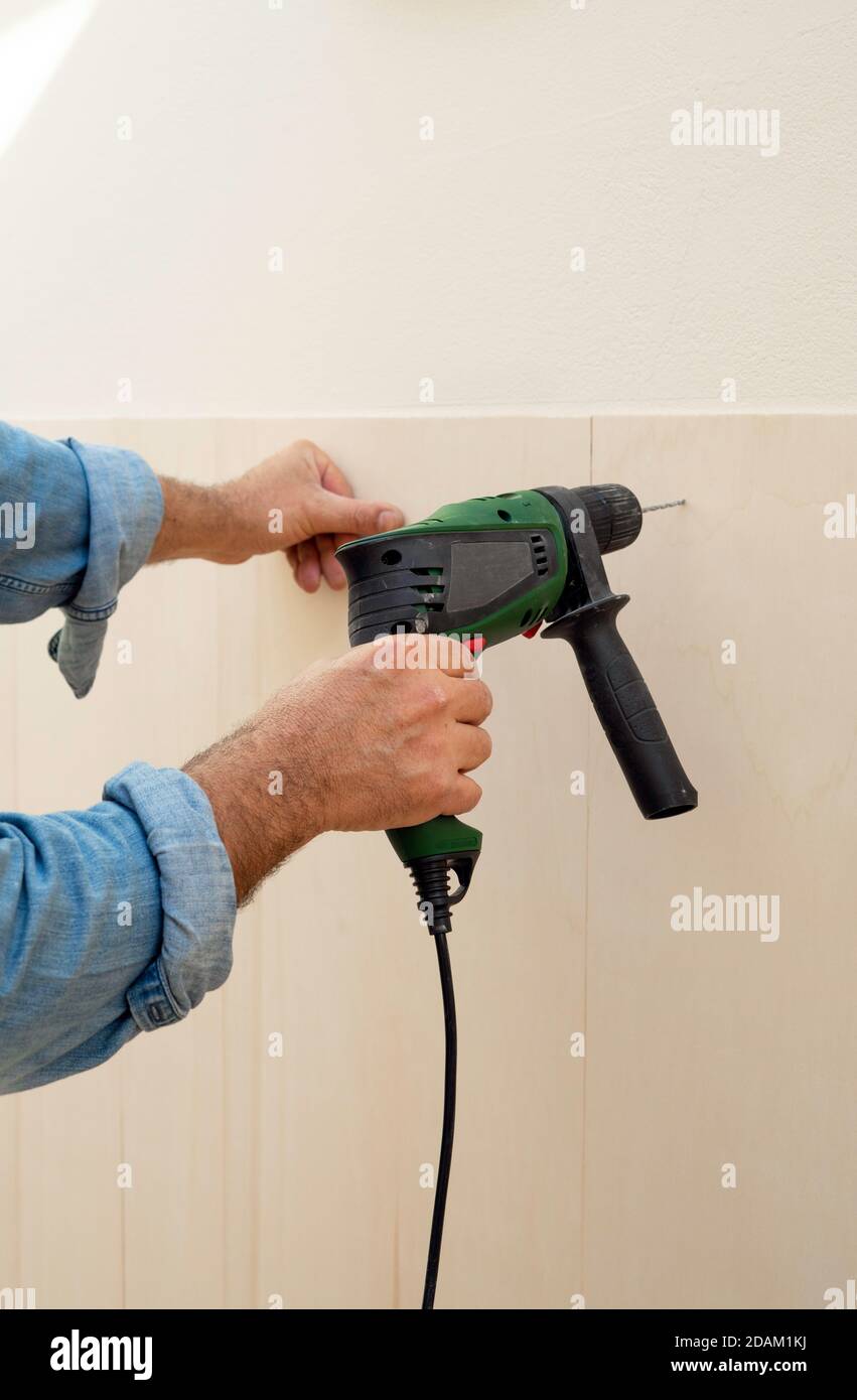Human hand holding drill machine Stock Photo - Alamy