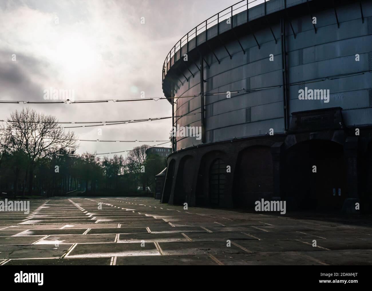 The old repurposed gas holder of the Westergas factory on a cold hazy ...