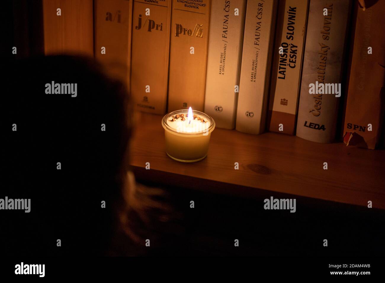 Soy candle lights old book in the library Stock Photo - Alamy