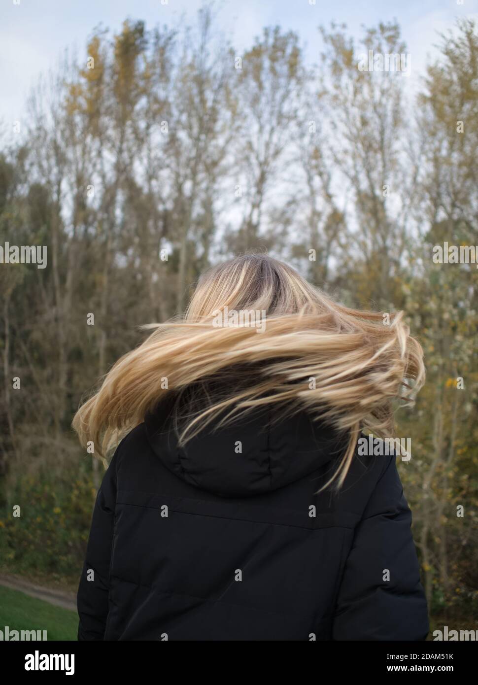 Back View of a Young Woman Tossing Her Long Blonde Hair in Autumn Park ...
