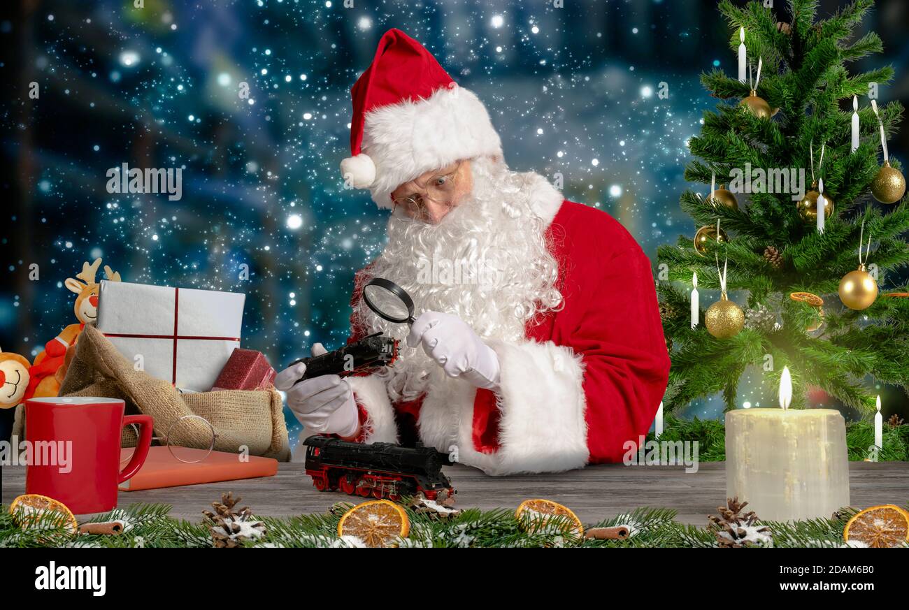 santa claus checks toys for quality in his workshop at the north pole ...