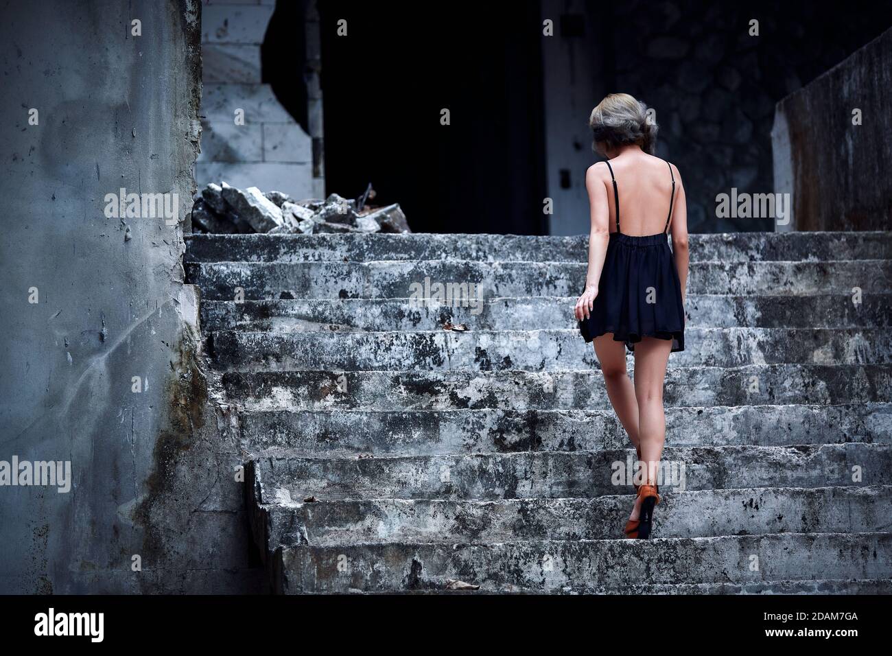 Beautiful girl posing on stairs in the abandoned ruined building Stock ...