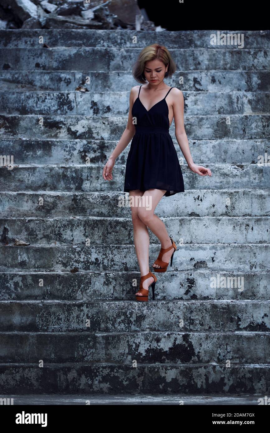 Beautiful girl posing on stairs in the abandoned ruined building Stock ...