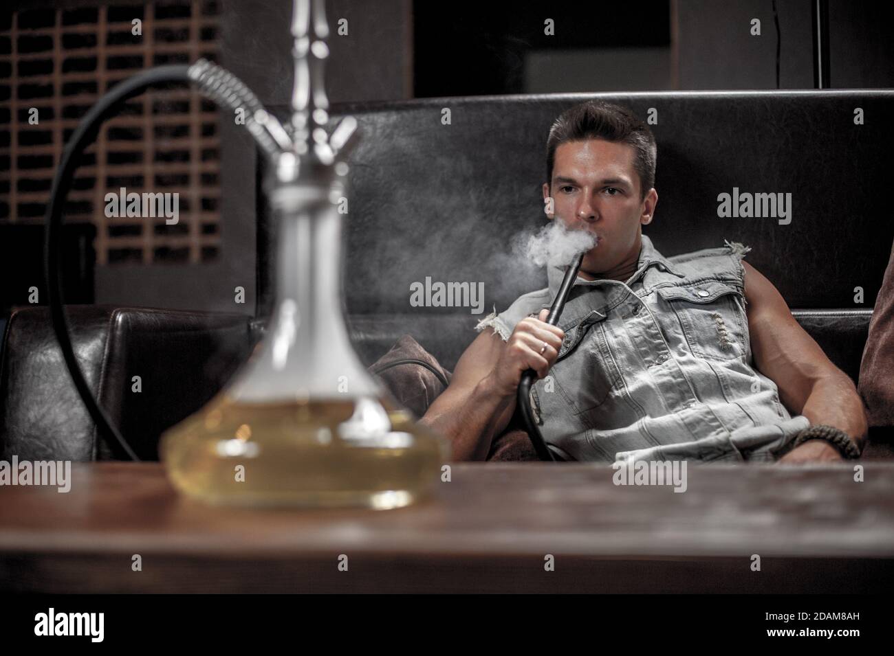 Man smoking hookah in the shisha hose Stock Photo - Alamy